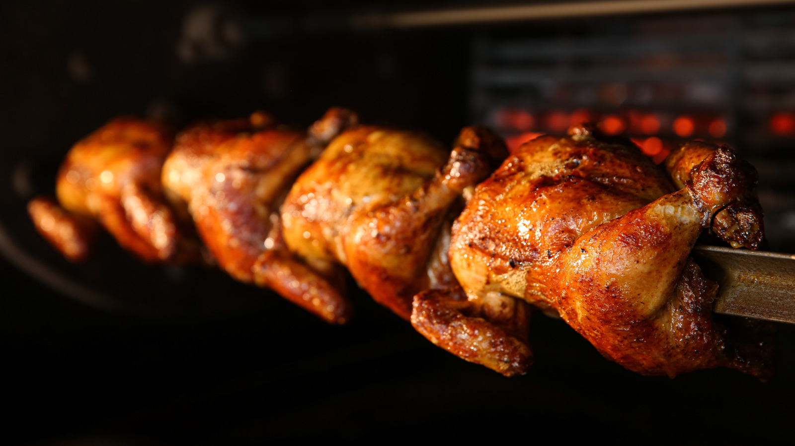 Here's Why Grocery Store Rotisserie Chickens Are Cheaper Than Raw Chickens