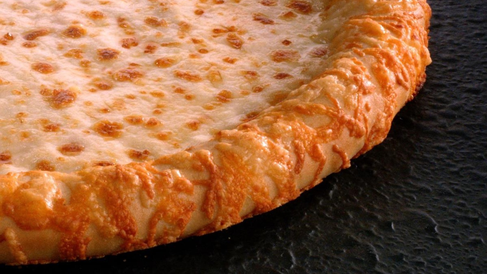 How Milk Overproduction Helped Create Pizza Hut's Cheesiest Pizzas