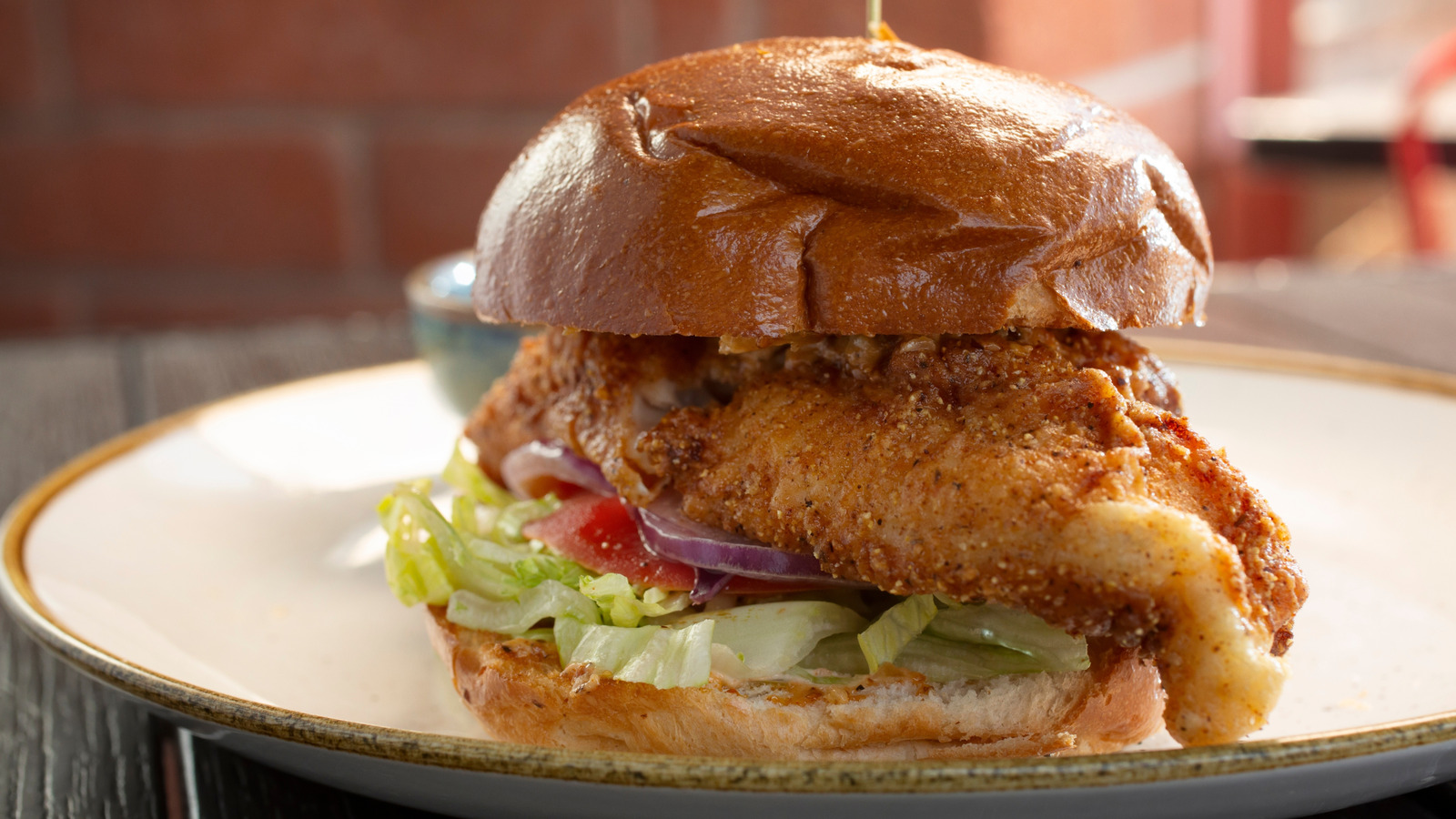 The Crunchy, Tangy Topping You Should Be Adding To Your Fish Sandwich