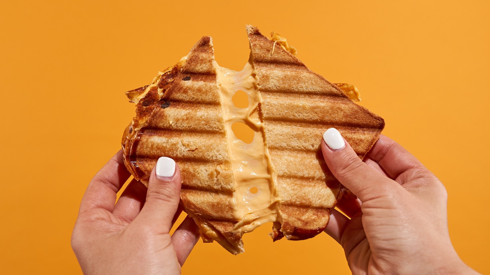 The Mistake That's Ruining Your Grilled Cheese Sandwich's Cheese Pull