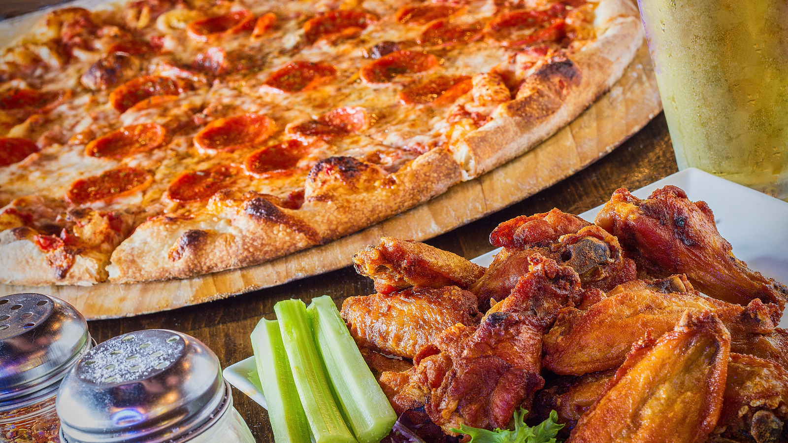 The Reason So Many Pizza Chains Also Serve Chicken Wings