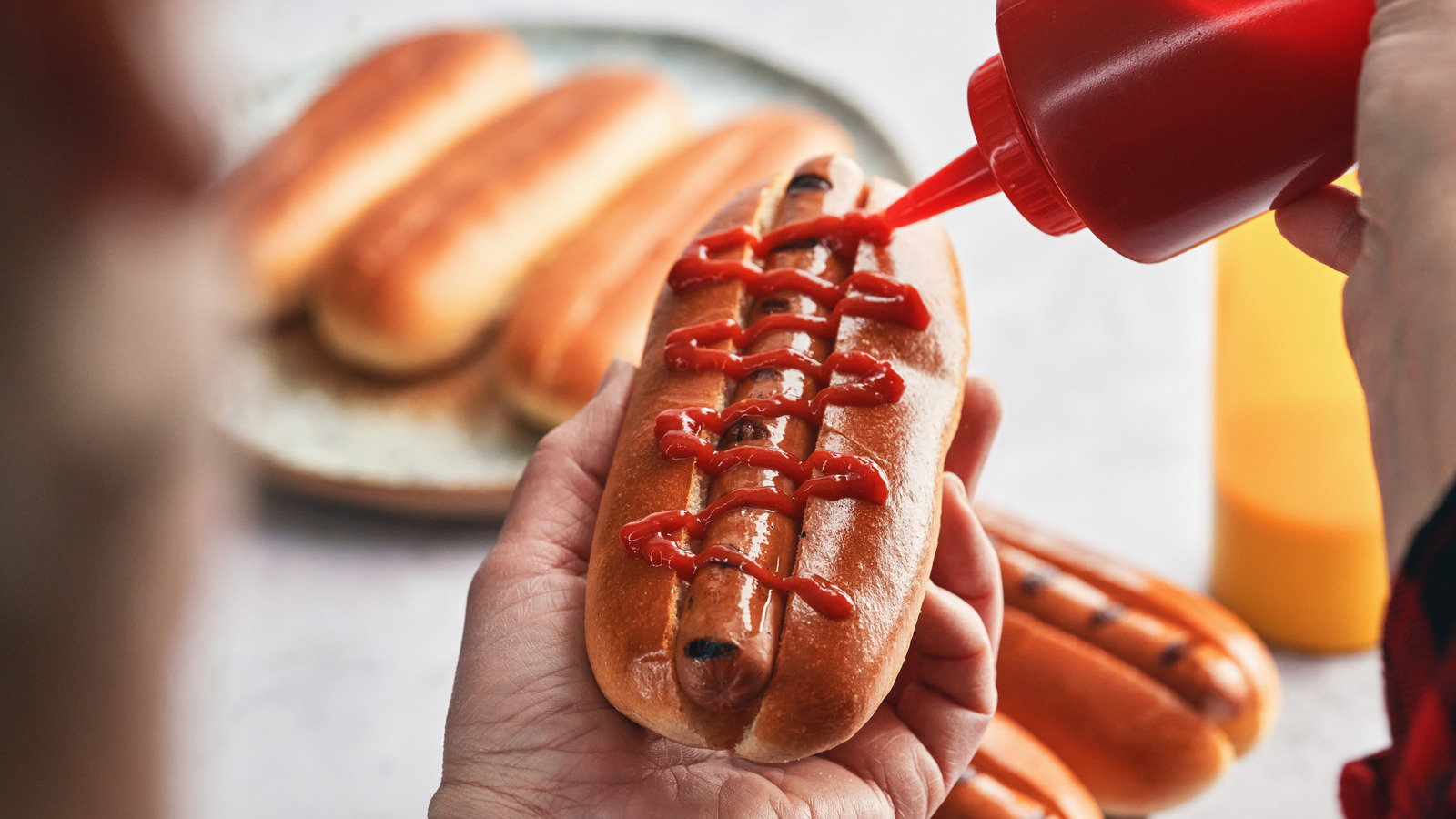 Why We Eat Ketchup On Hot Dogs (And Why Some People Think You Never Should)